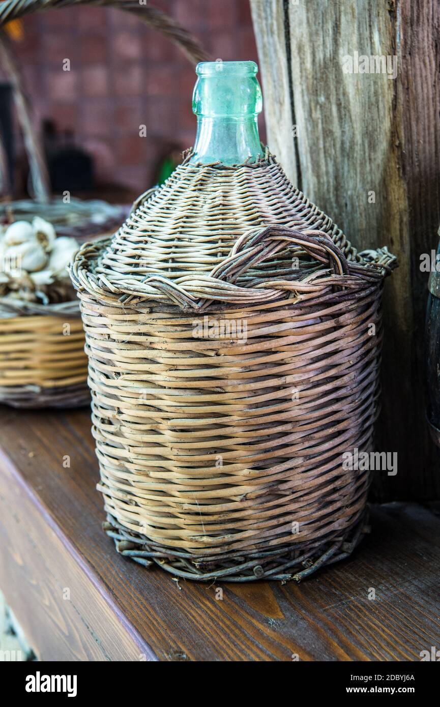 an old flask with a straw roof woven into an old country cottage Stock ...