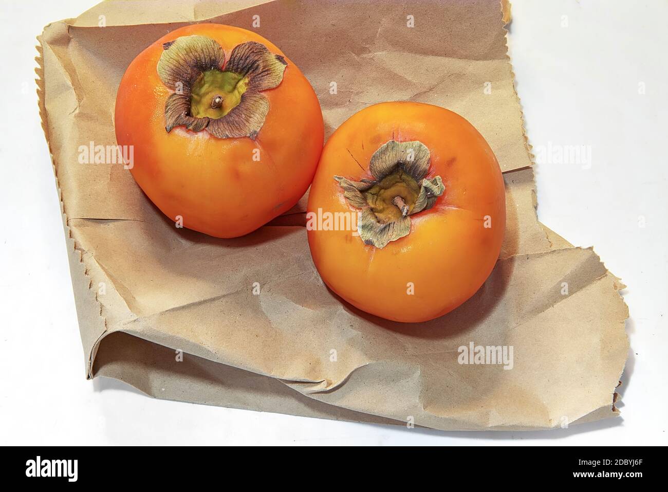 Persimmon Fruit. Isolated. Copy Space. Lotus fruit laid on a brown ...