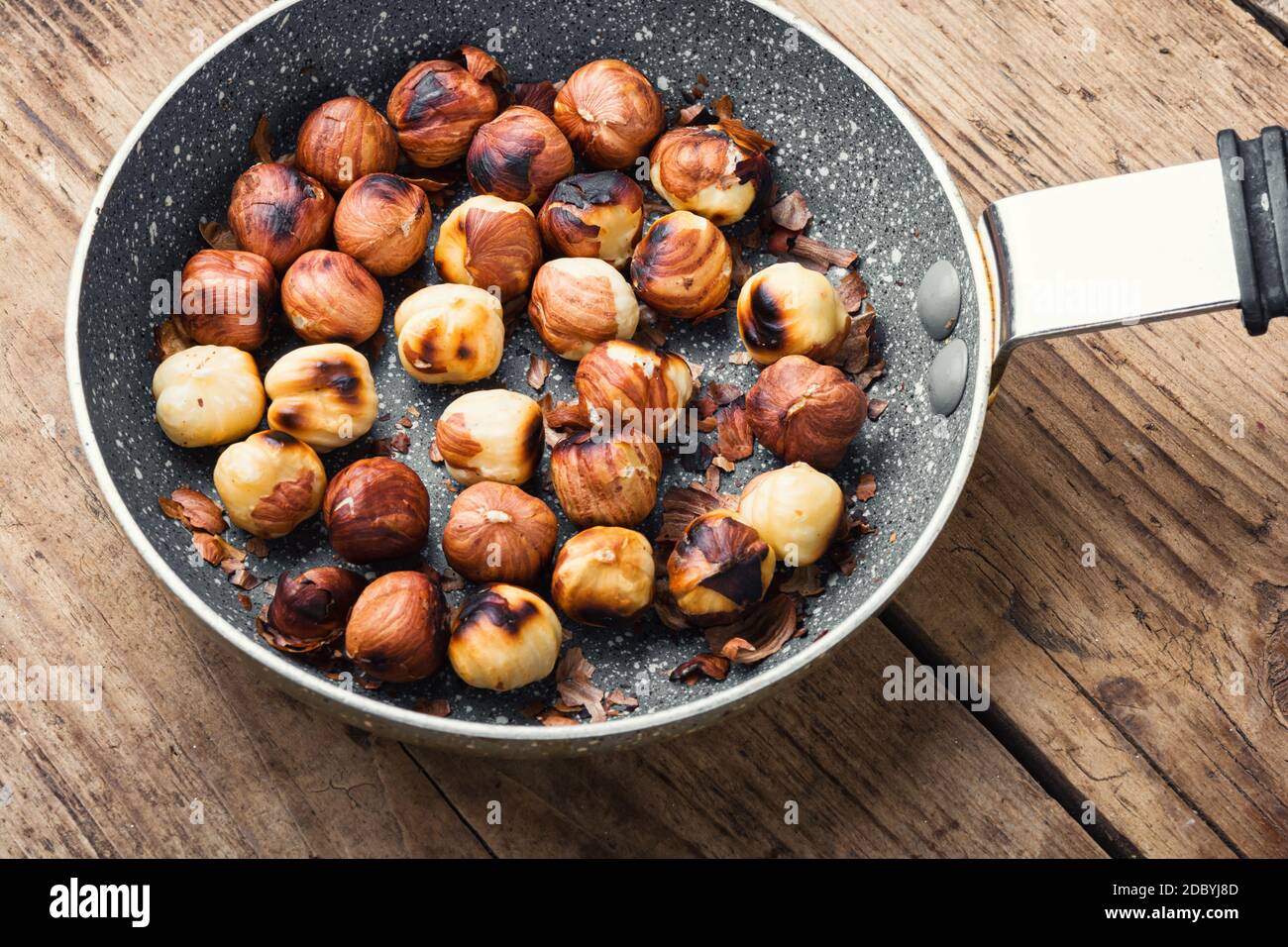 Pile of roasted peeled hazelnuts.Hazelnut fried in a frying pan Stock ...