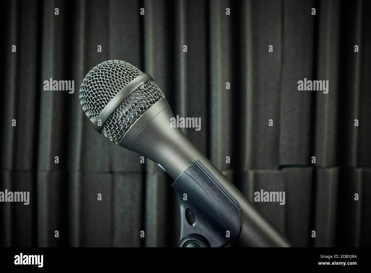 Side view microphone mounted on mic stand and acoustic foam background ...