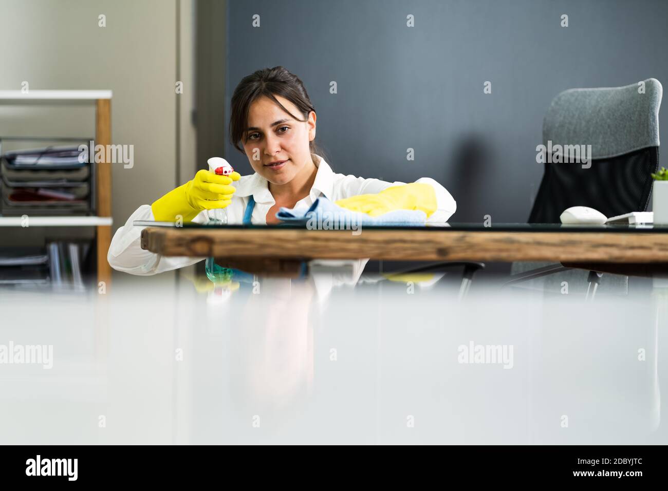 Janitor Cleaning Office Desk. Hygiene Cleaner Service Stock Photo - Alamy