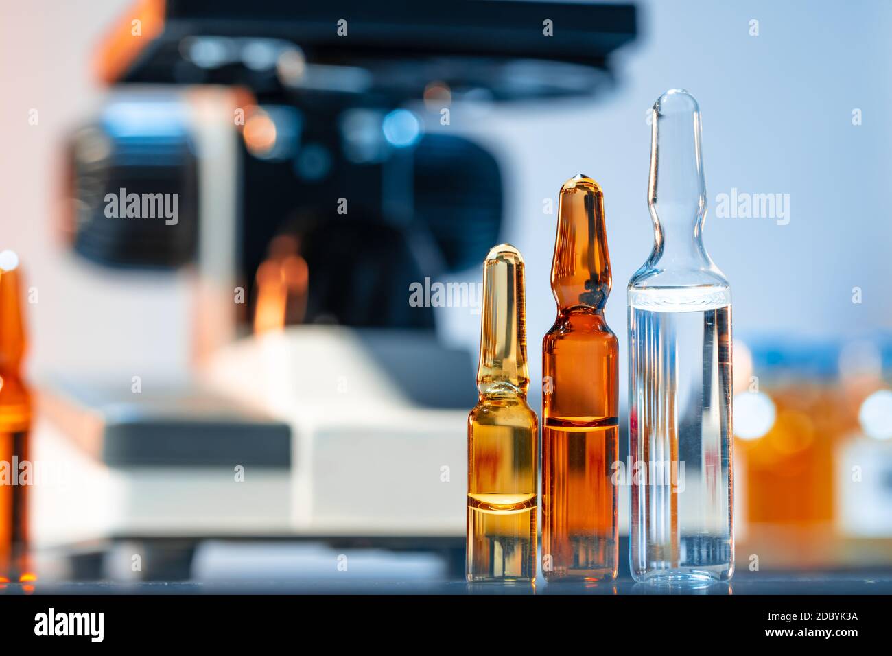 Medical vial with medication near microscope photo Stock Photo - Alamy