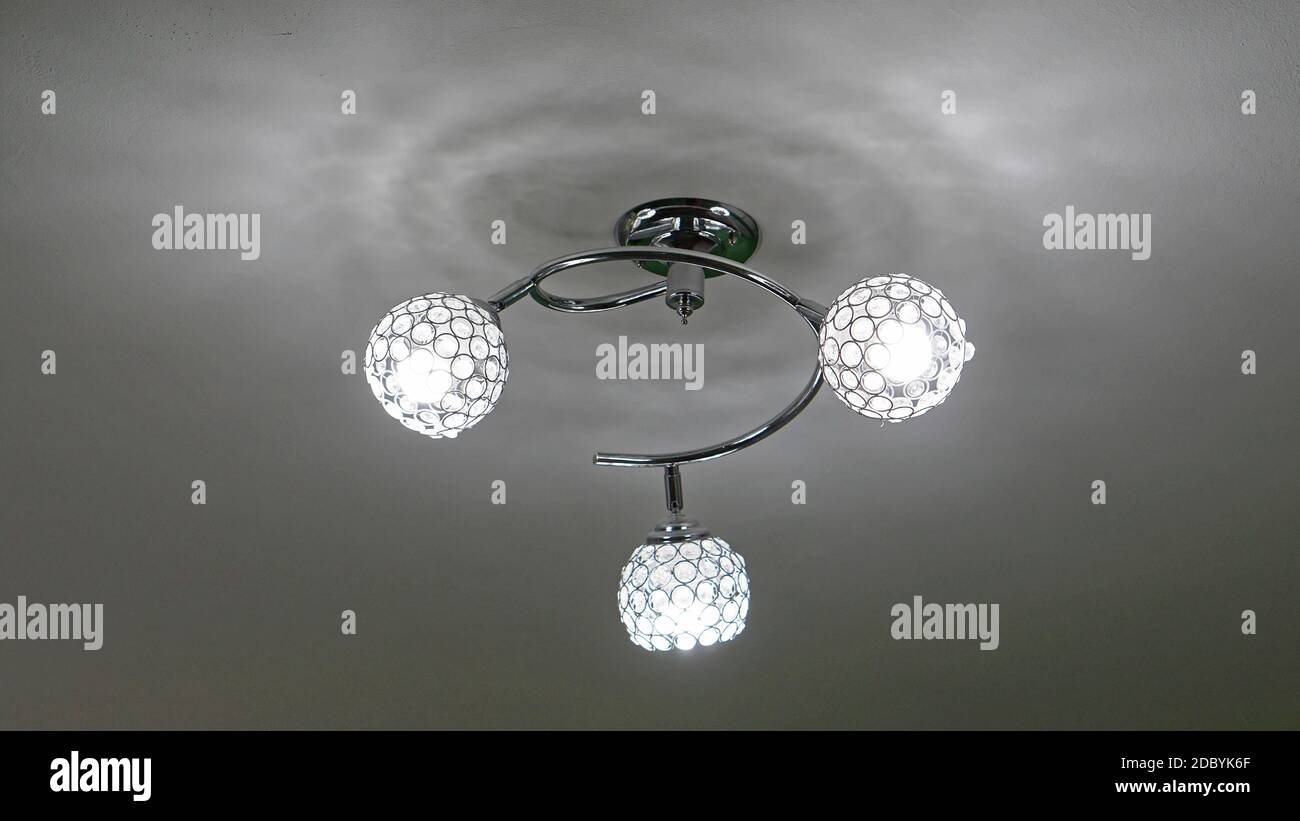 Modern chandelier with three led light bulbs Stock Photo - Alamy
