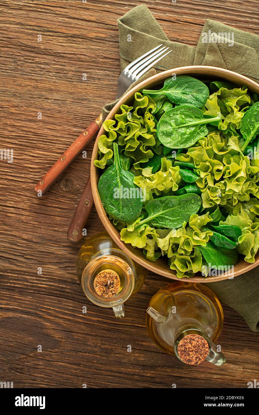 Healthy green salad with dressing on wooden table background. Healthy ...