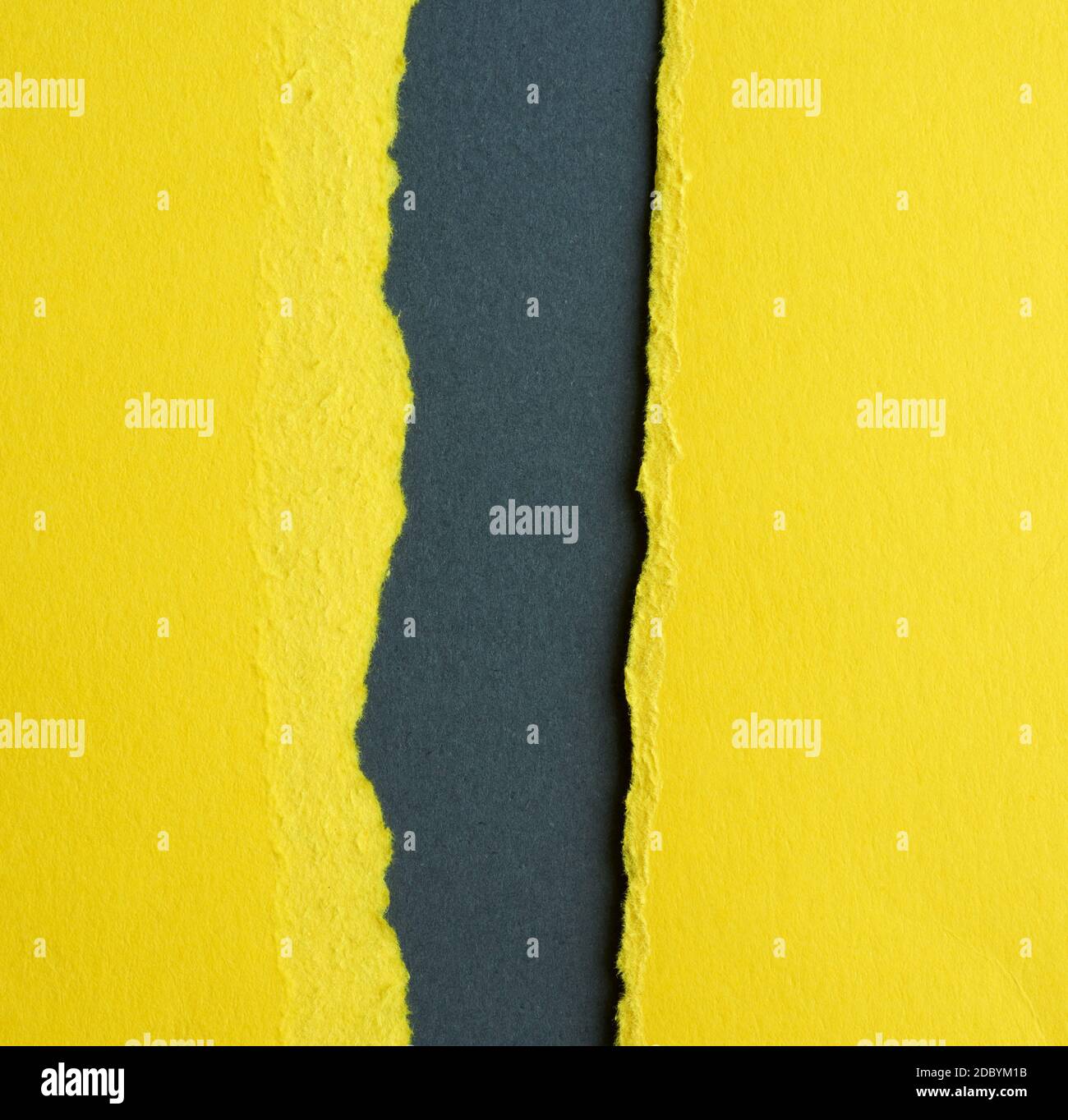 background of layered yellow torn paper with a shadow on a black ...