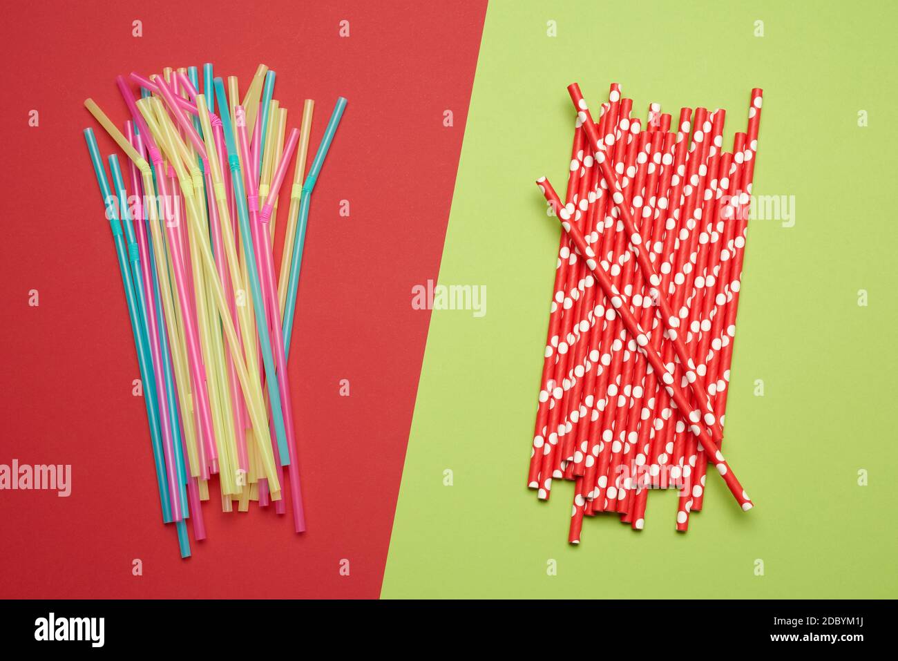 paper colorful cocktail straws and stack of plastic straws on pink ...