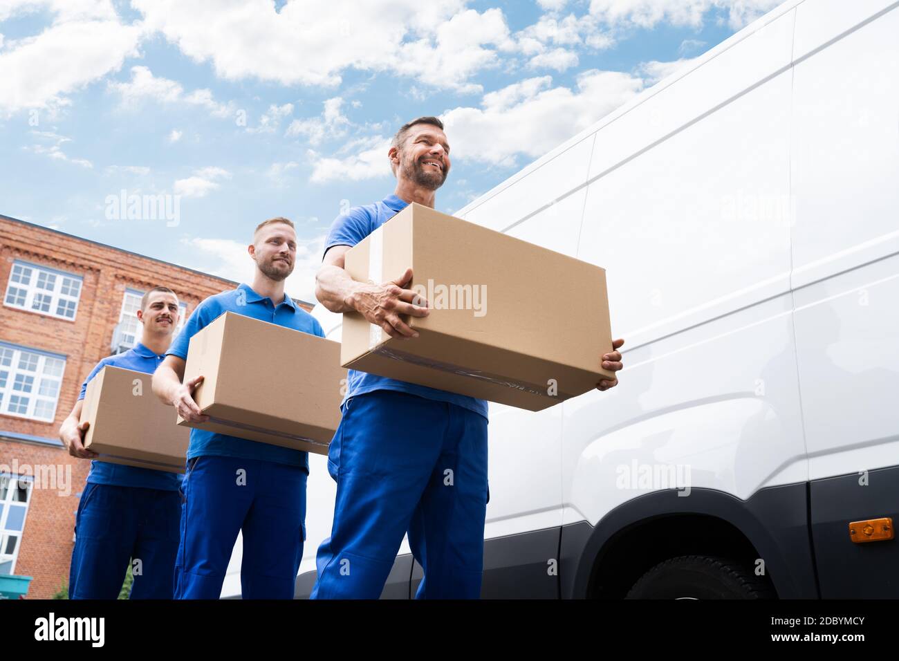 Truck Movers Loading Van Carrying Boxes And Moving House Stock Photo ...