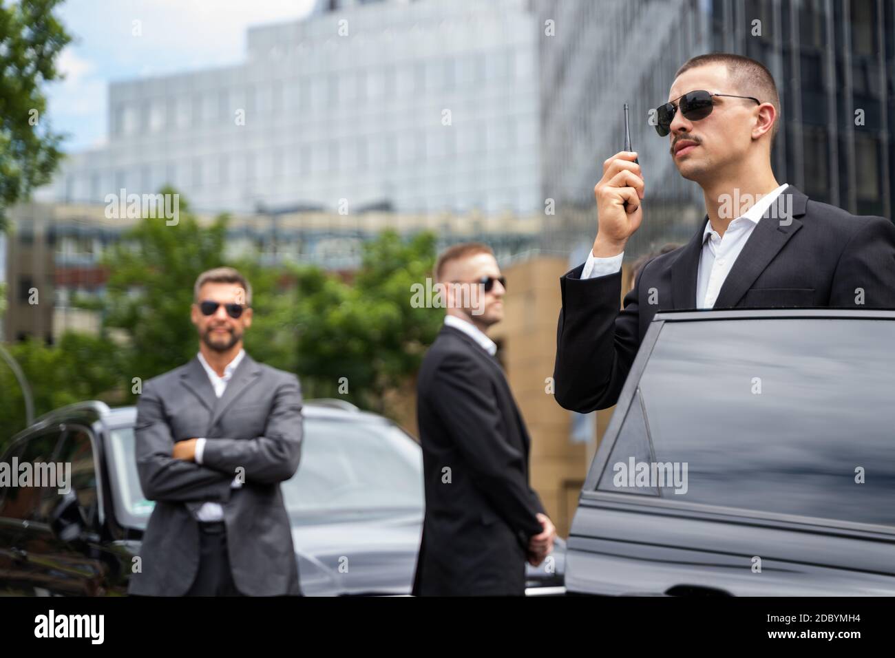 Business Security Guard Service At Work Near Luxury Car Stock Photo - Alamy