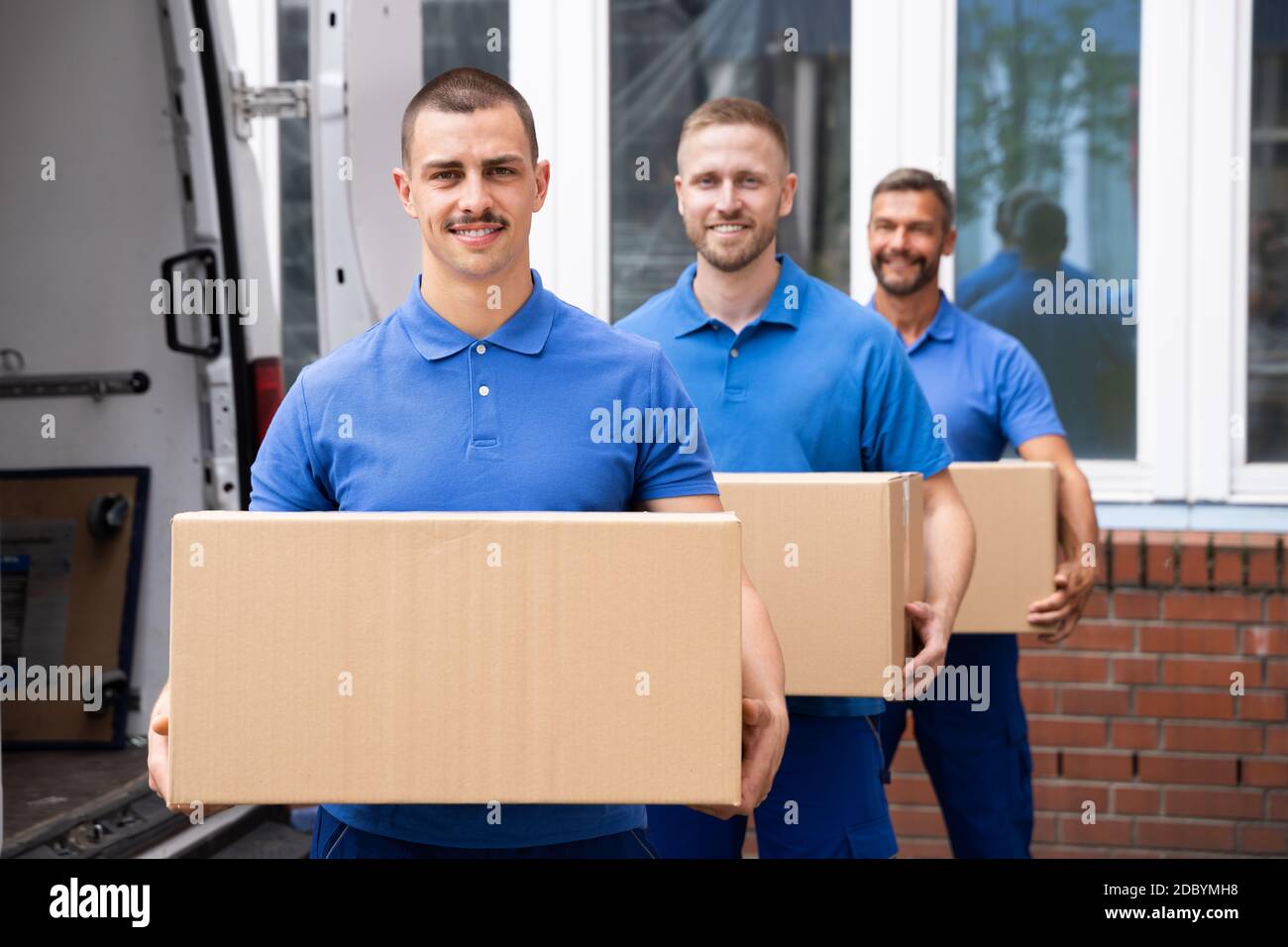Truck Movers Loading Van Carrying Boxes And Moving House Stock Photo ...