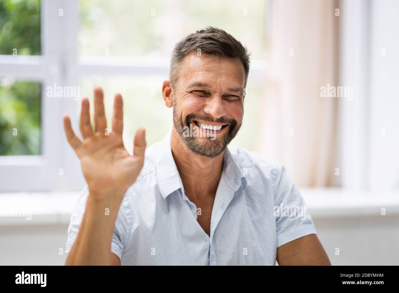 Man Portrait Waving Hello In Video Conference Stock Photo - Alamy