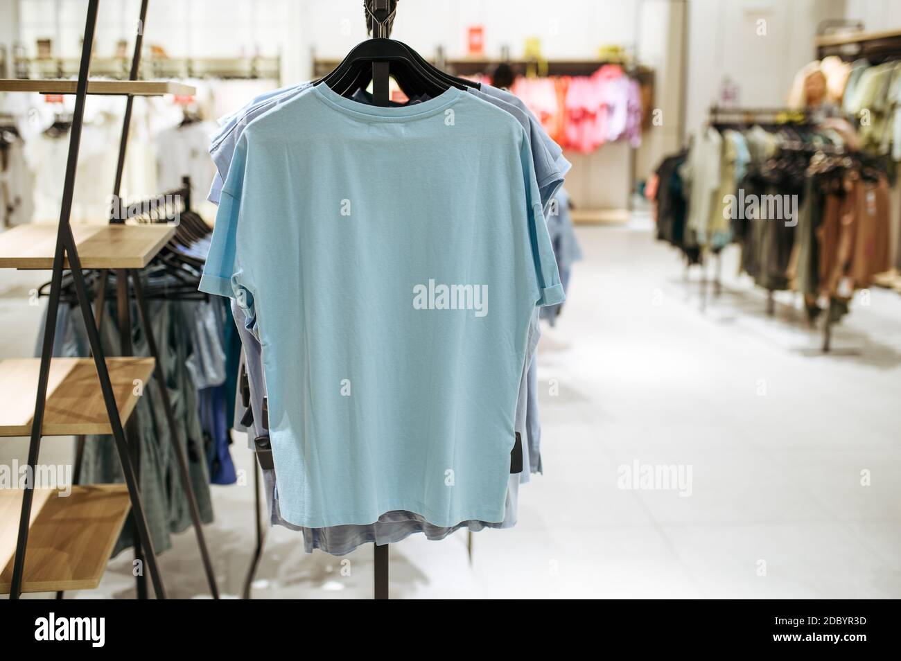 Clothes on hangers in clothing store, nobody. Fashion shop or boutique ...