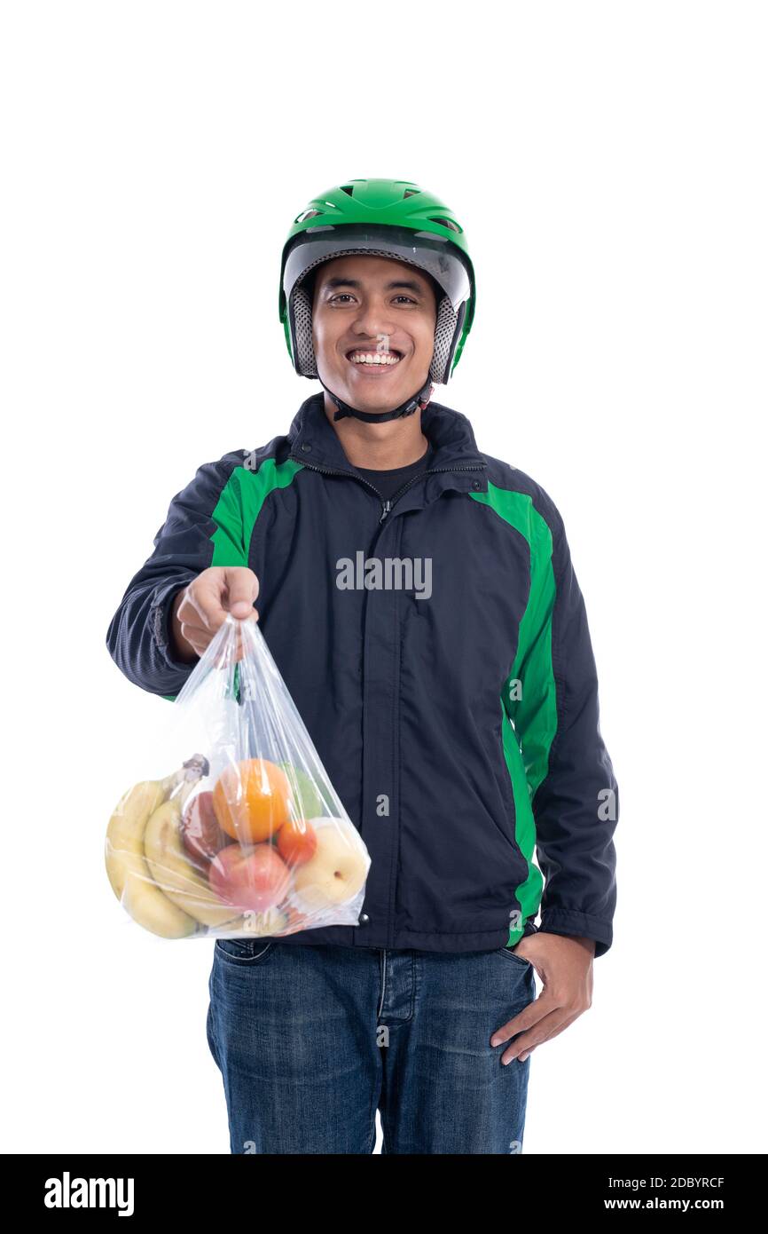 grocery delivery. courier wearing helmet and jacket uniform holding ...