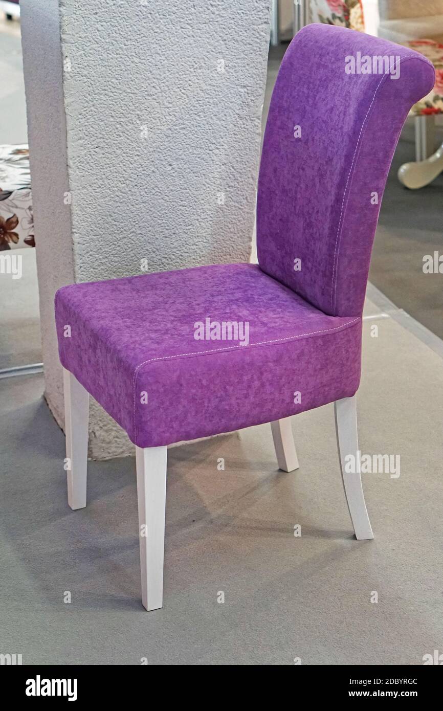 Purple textile chair in home interior Stock Photo - Alamy