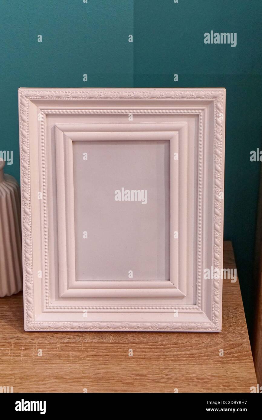 White portrait picture frame at night table Stock Photo - Alamy