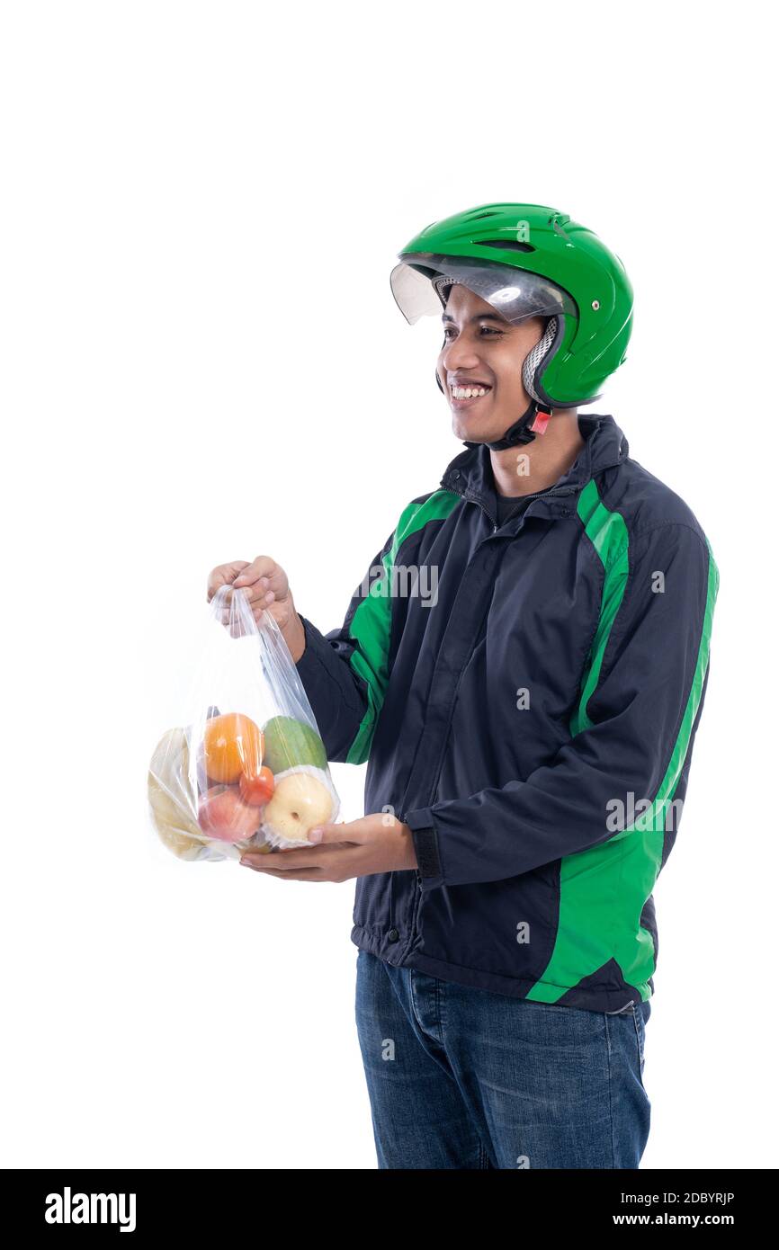grocery delivery. courier wearing helmet and jacket uniform holding ...