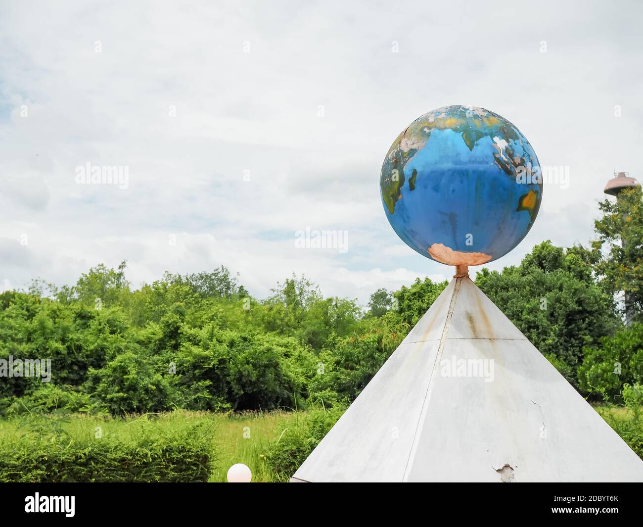 A model globe is placed on a triangular platform Stock Photo - Alamy