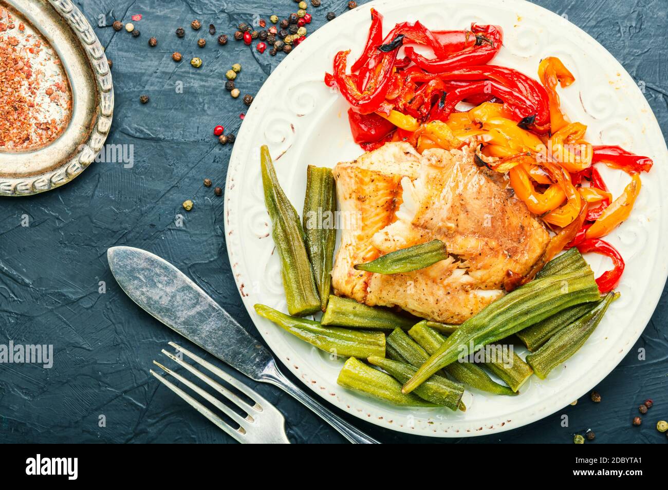 Baked fish with okra and red pepper.Fish grenadier Stock Photo - Alamy