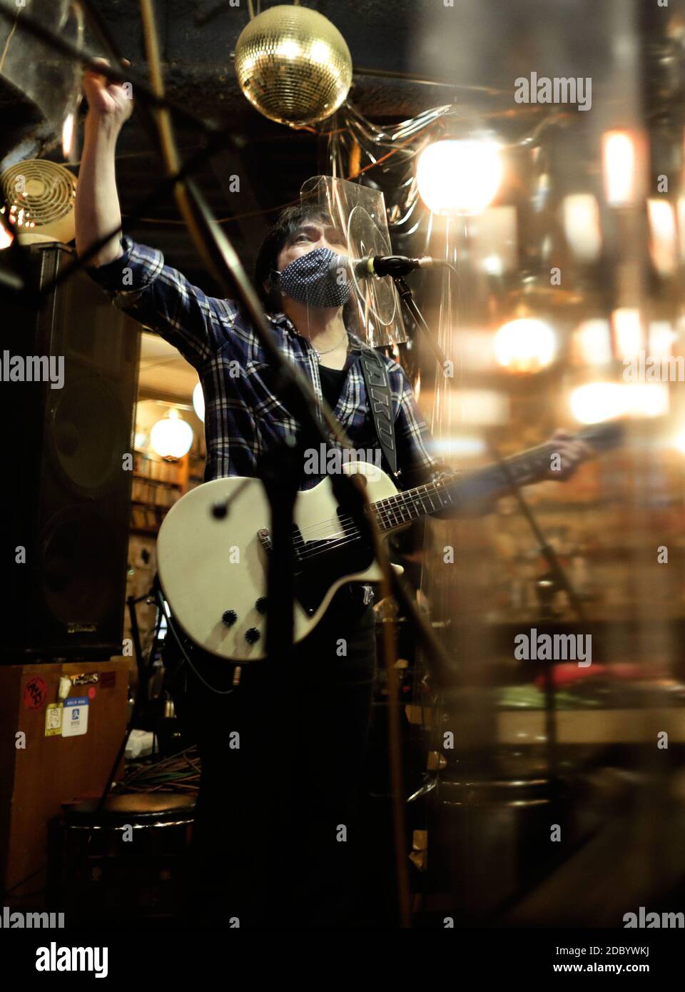 A musician wearing a face mask performs at a bar in Osaka on Oct. 6 ...