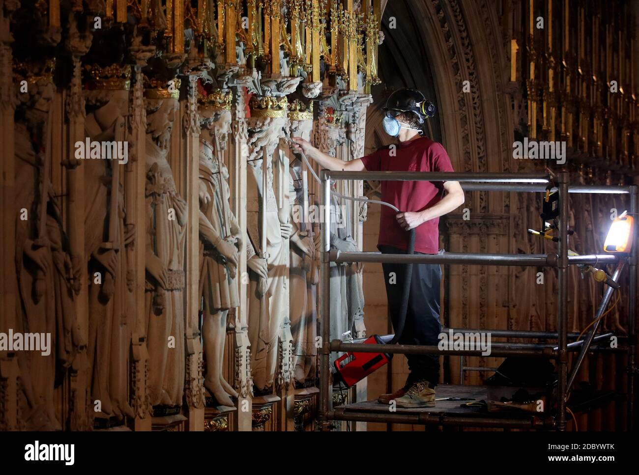 Conservation workers using museum grade vacuums and brushes begin the ...