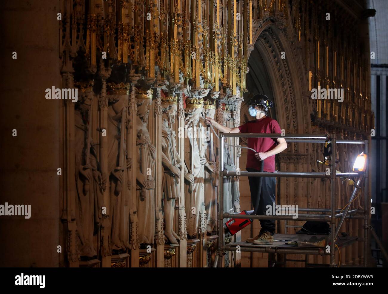 Conservation workers using museum grade vacuums and brushes begin the ...