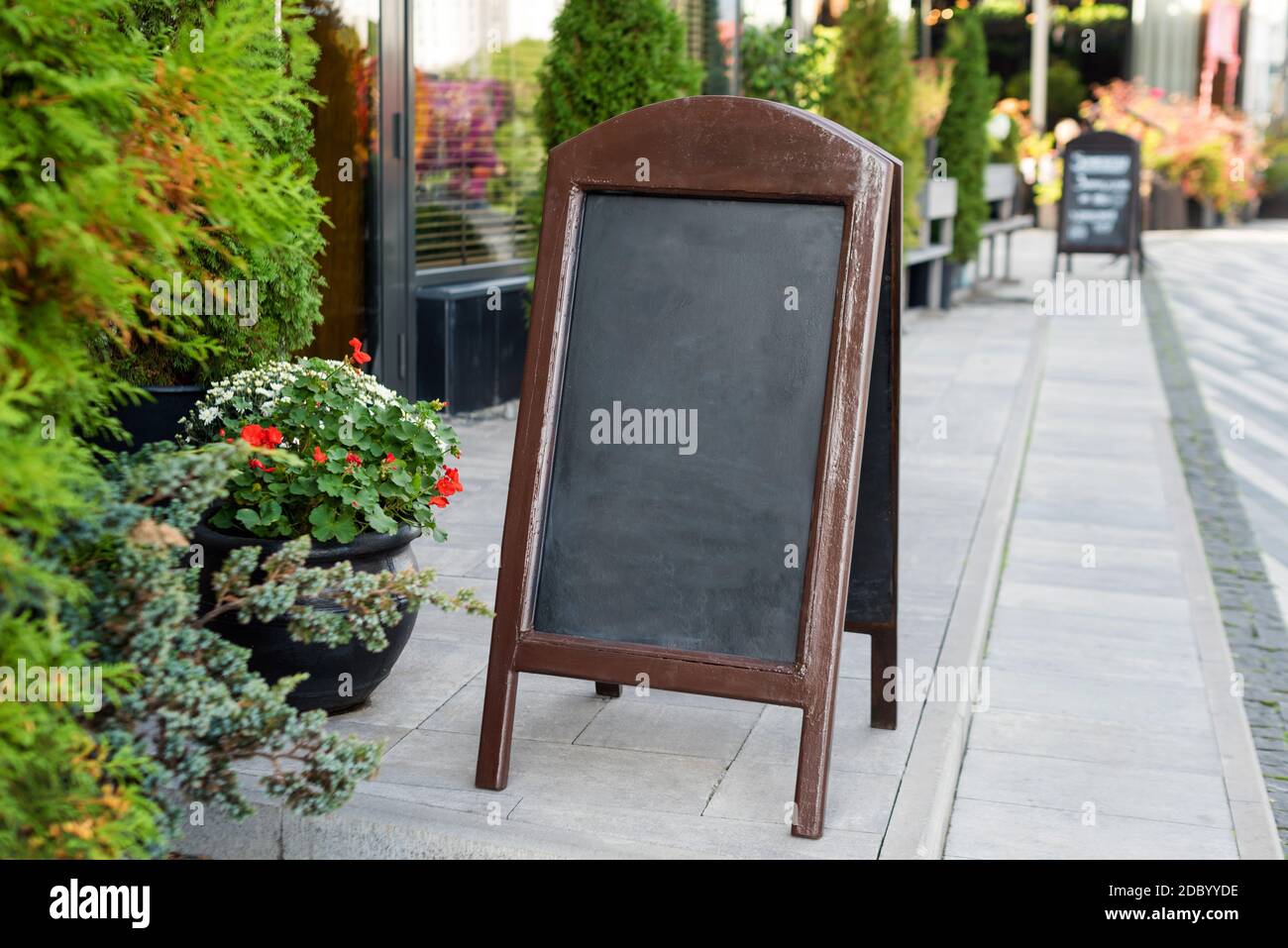 Signboard on the street. Empty menu board stand. Restaurant sidewalk ...