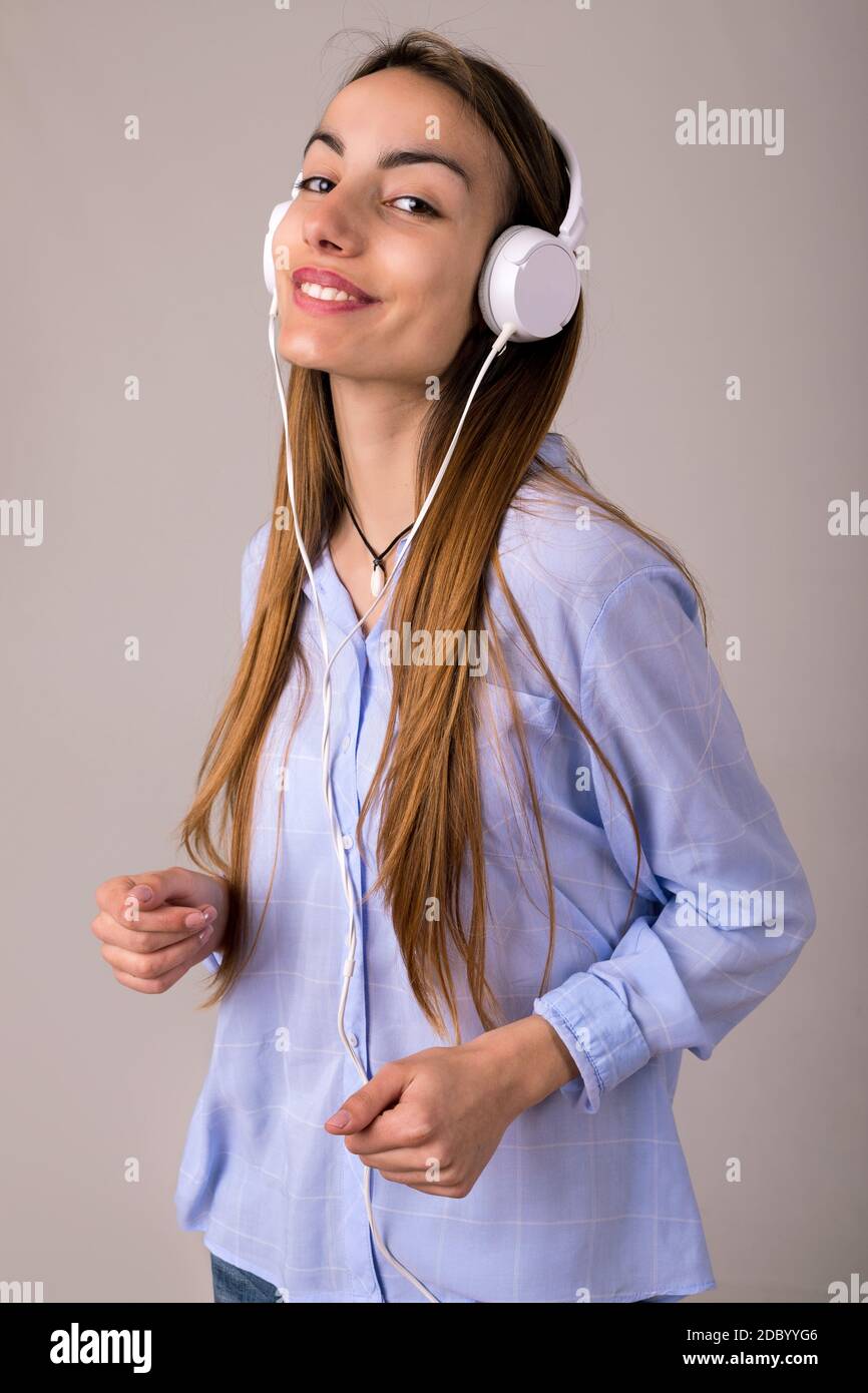 Beautiful young woman listen music with headphones Stock Photo - Alamy