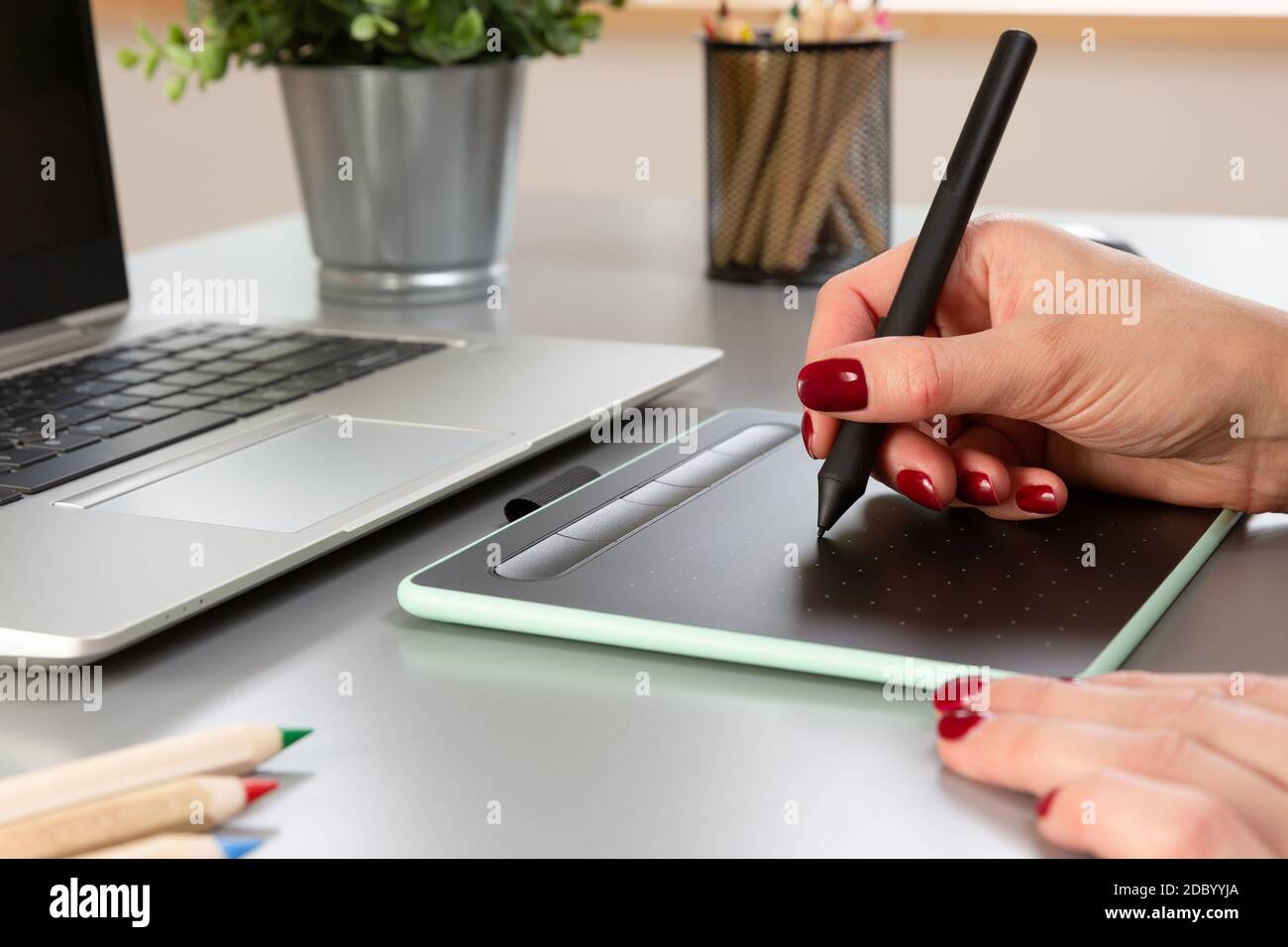 Beautiful graphic designer drawing digital design on a drawing tablet ...