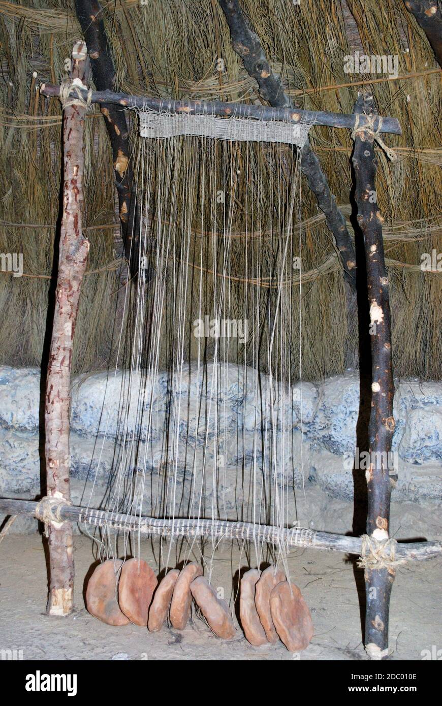 Stone age material weaving frame inside a hut in the Mondragon Palace ...