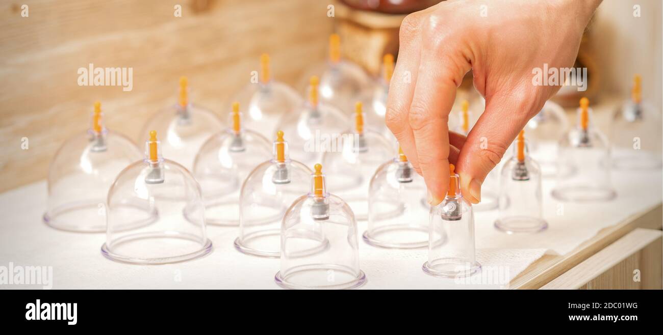 Masseur takes vacuum massage glass jars of traditional Chinese cupping ...