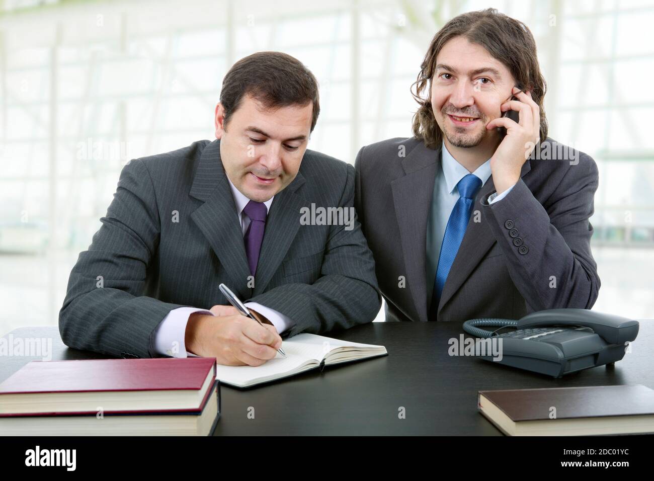 business team working at a desk at the office Stock Photo - Alamy