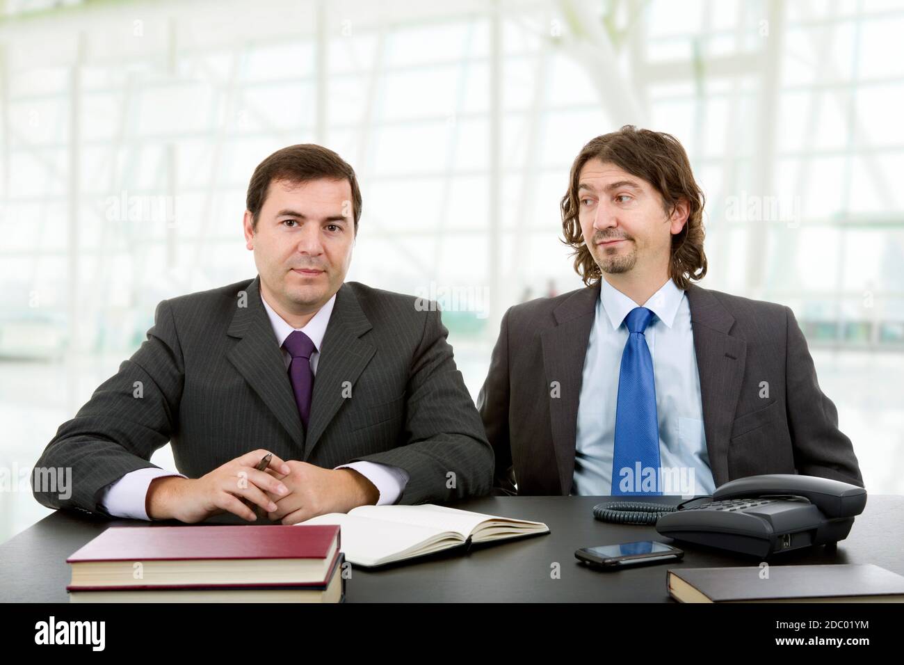 business team working at a desk at the office Stock Photo - Alamy