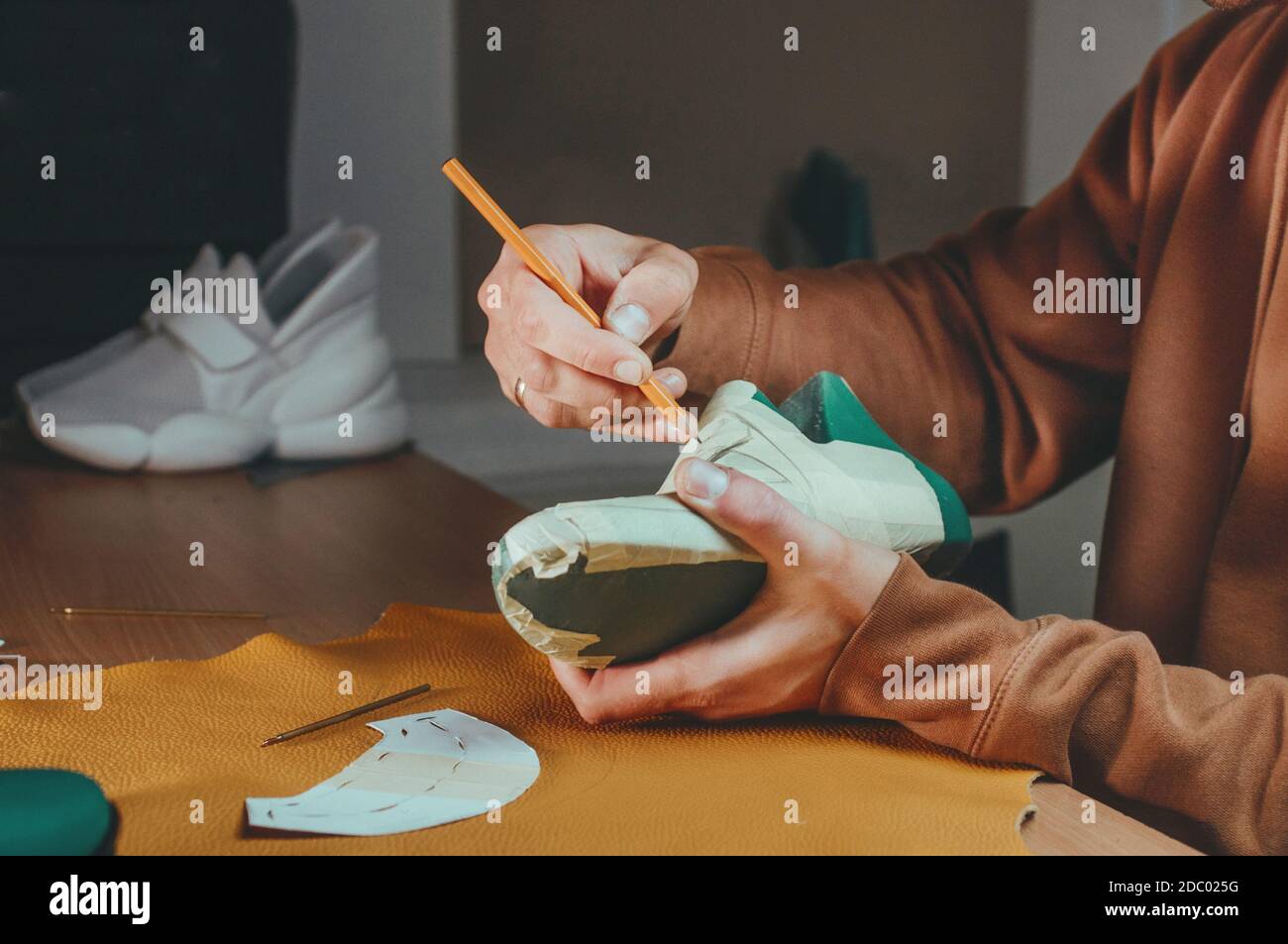Close up of shoemaker drawing a pattern on the shoe model Stock Photo ...