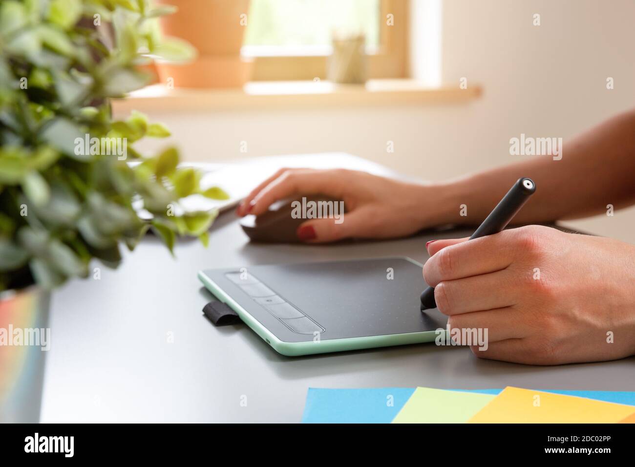 Beautiful graphic designer drawing digital design on a drawing tablet ...