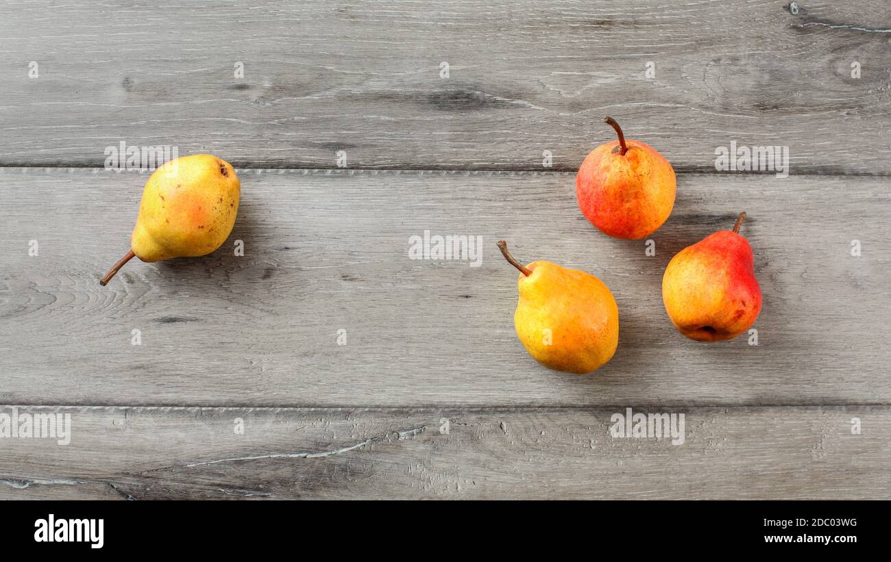 Table top view on four ripe pears placed on gray wood desk Stock Photo ...
