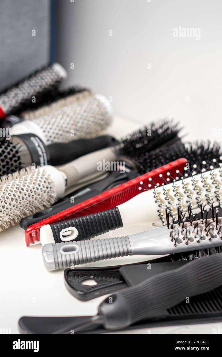 Set of different hair brushes and combs lying on the white table Stock ...