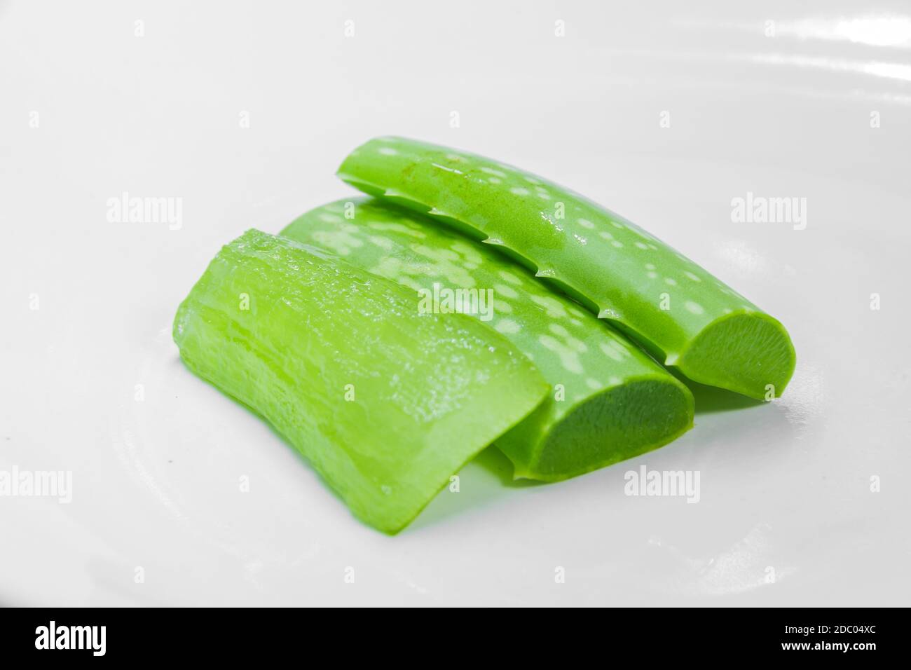 Cut aloe vera leaves isolated on white Stock Photo - Alamy