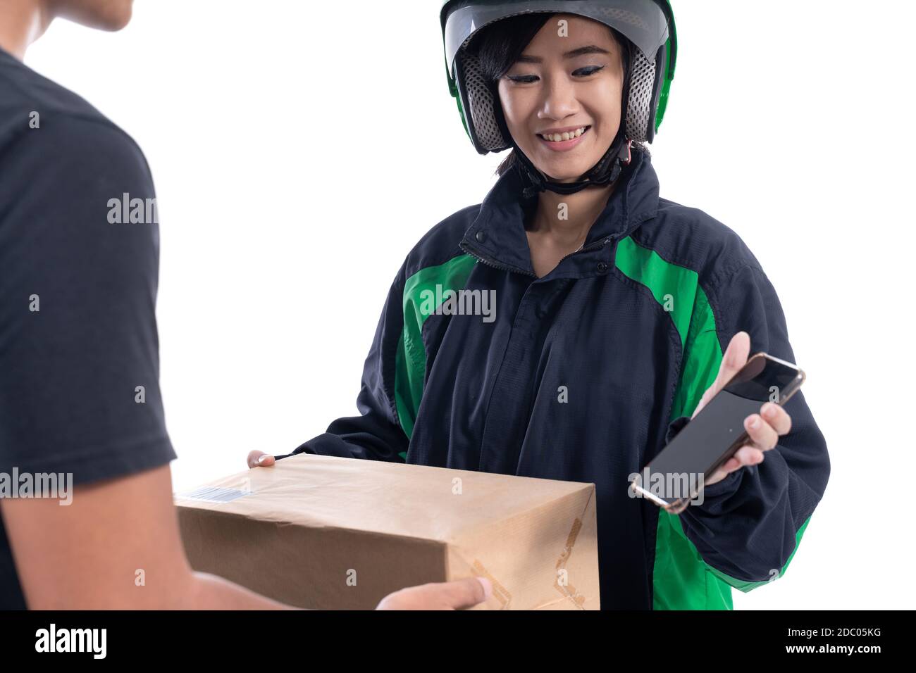 man signing to package he received from delivery courier Stock Photo ...