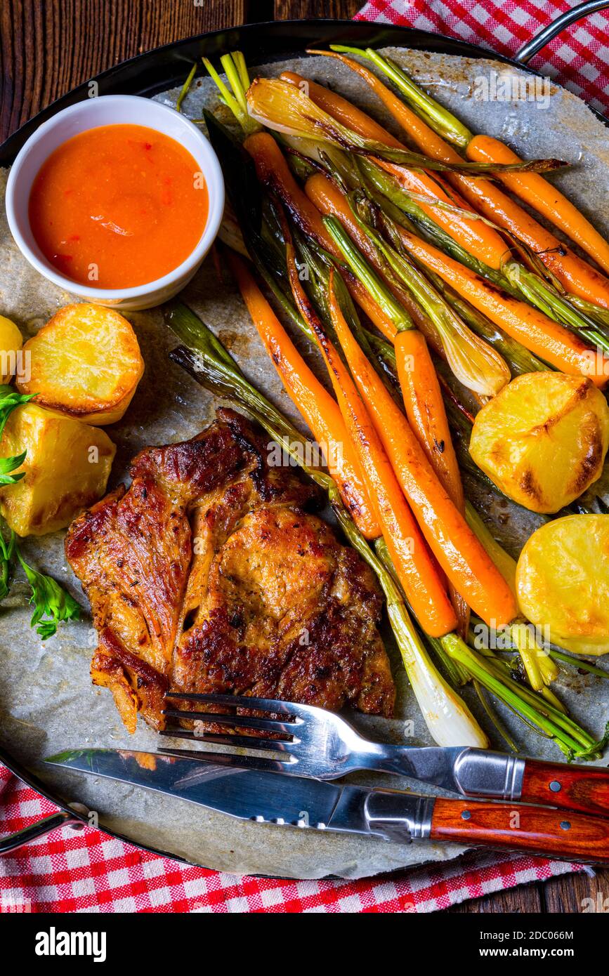 grilled neck chops with caramelized vegetables Stock Photo - Alamy
