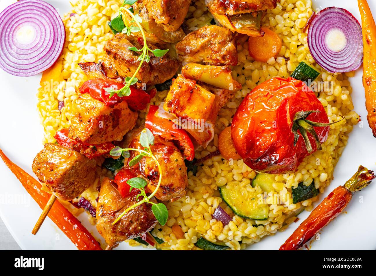 Shish kebabs with vegetables and bulgur Stock Photo - Alamy