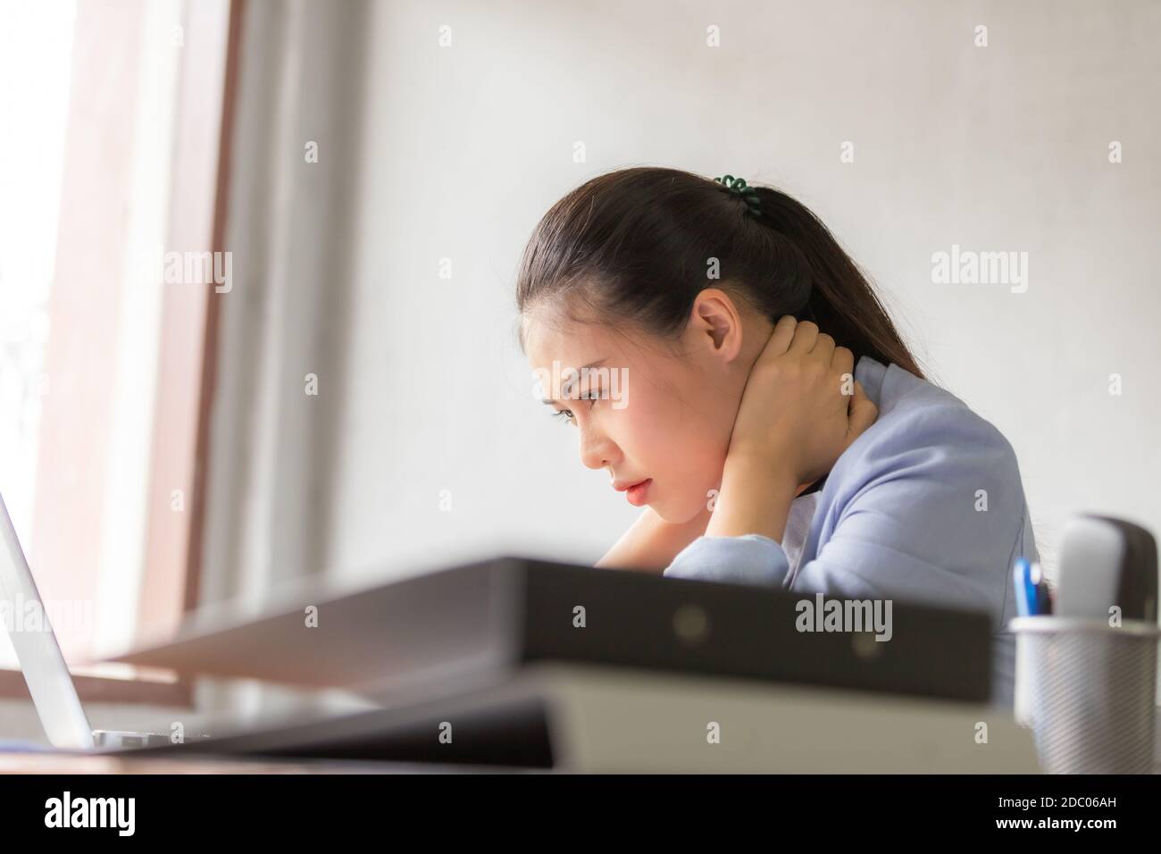 Asia business women feeling headache and stress. She is working at the ...