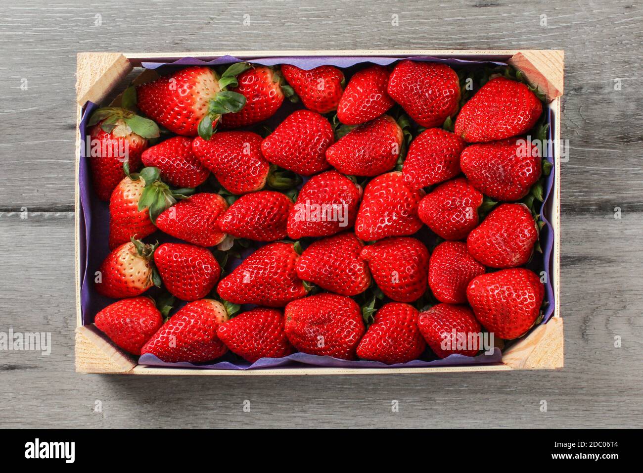 Table top view on small box of strawberries from supermarket placed on ...