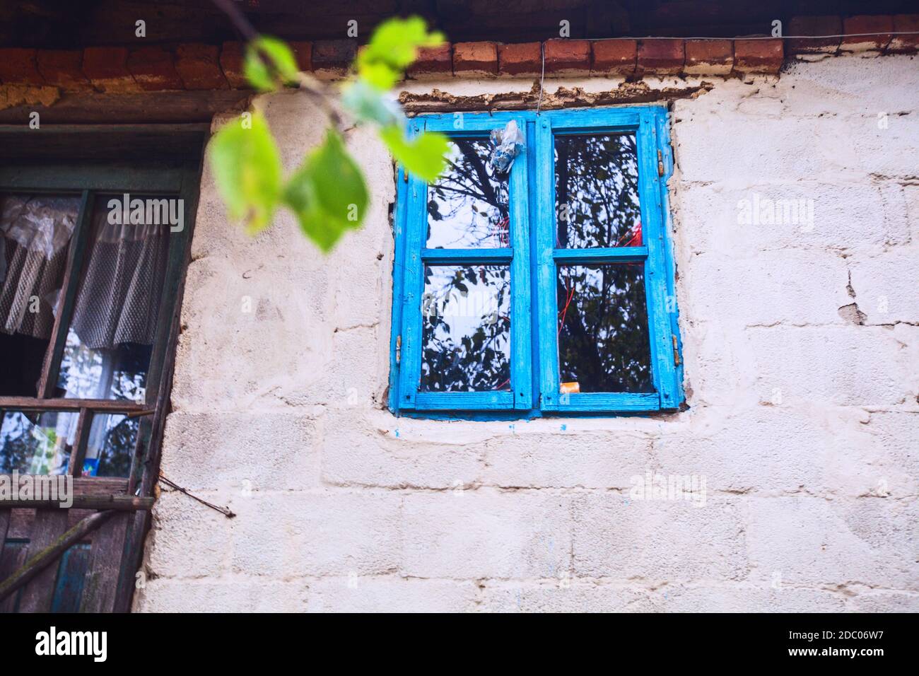 Wooden blue retro window on the old rural house Stock Photo - Alamy