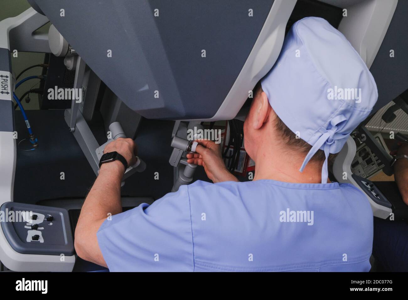 Hands of a surgeon operating a surgical robot. The process of ...