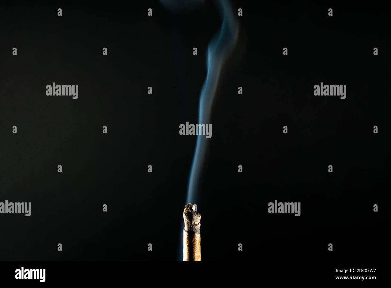 A Cannabis Cigar With Smoke Flowing From it on a Black Background Stock ...