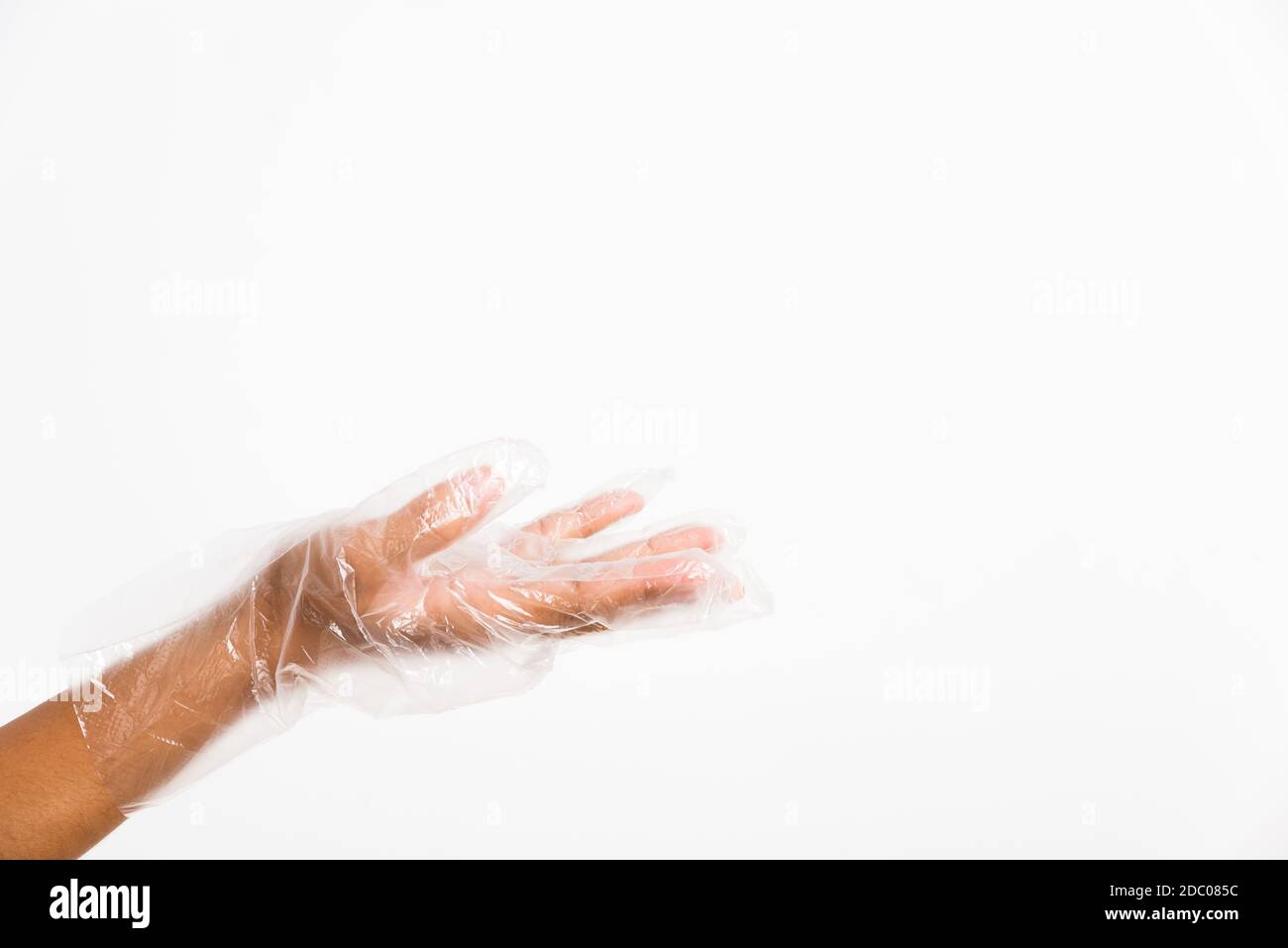 Woman hand wearing single use protect disposable transparent plastic ...
