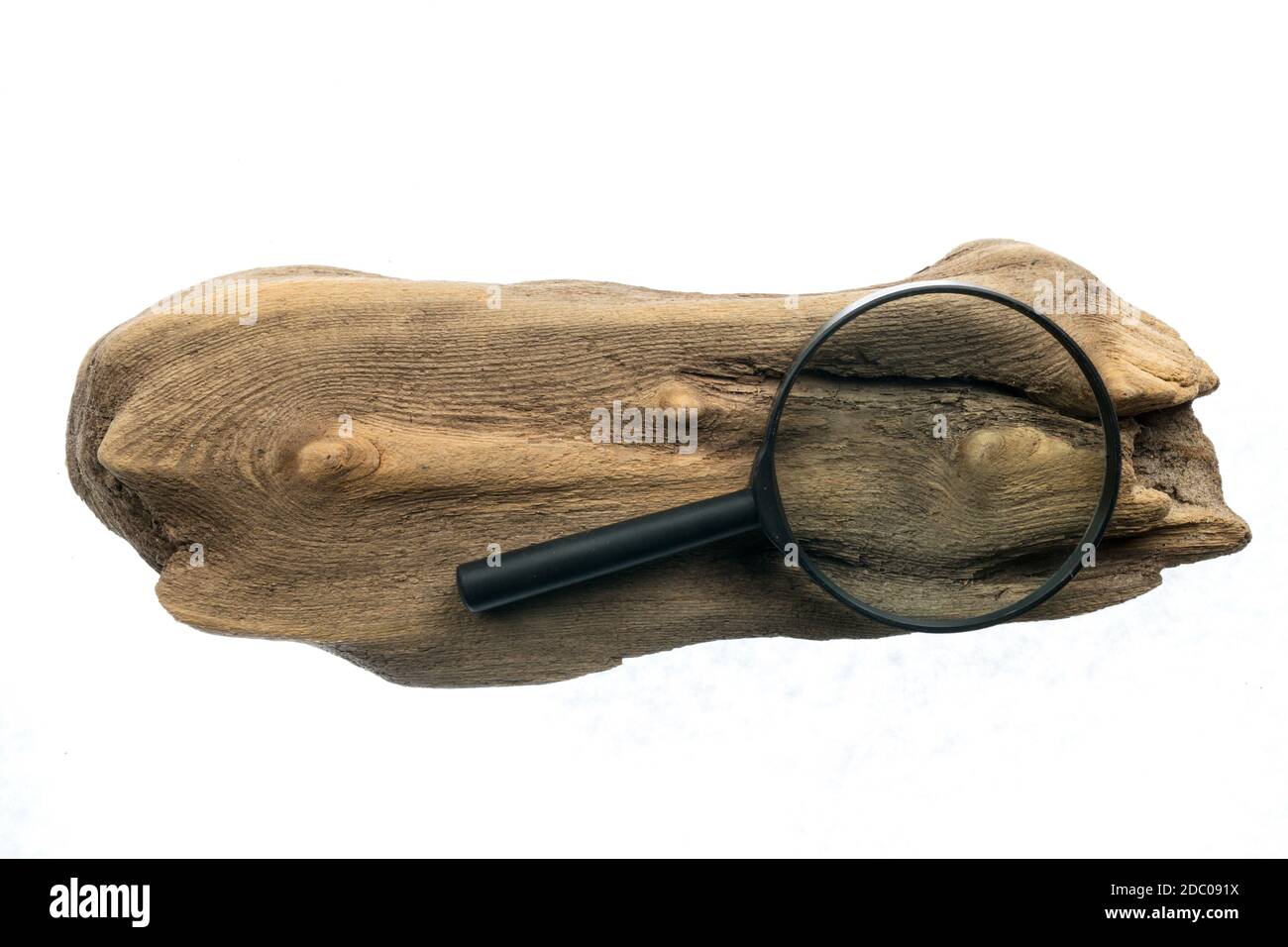Magnifying glass lying on an old wooden board. Isolated on white ...
