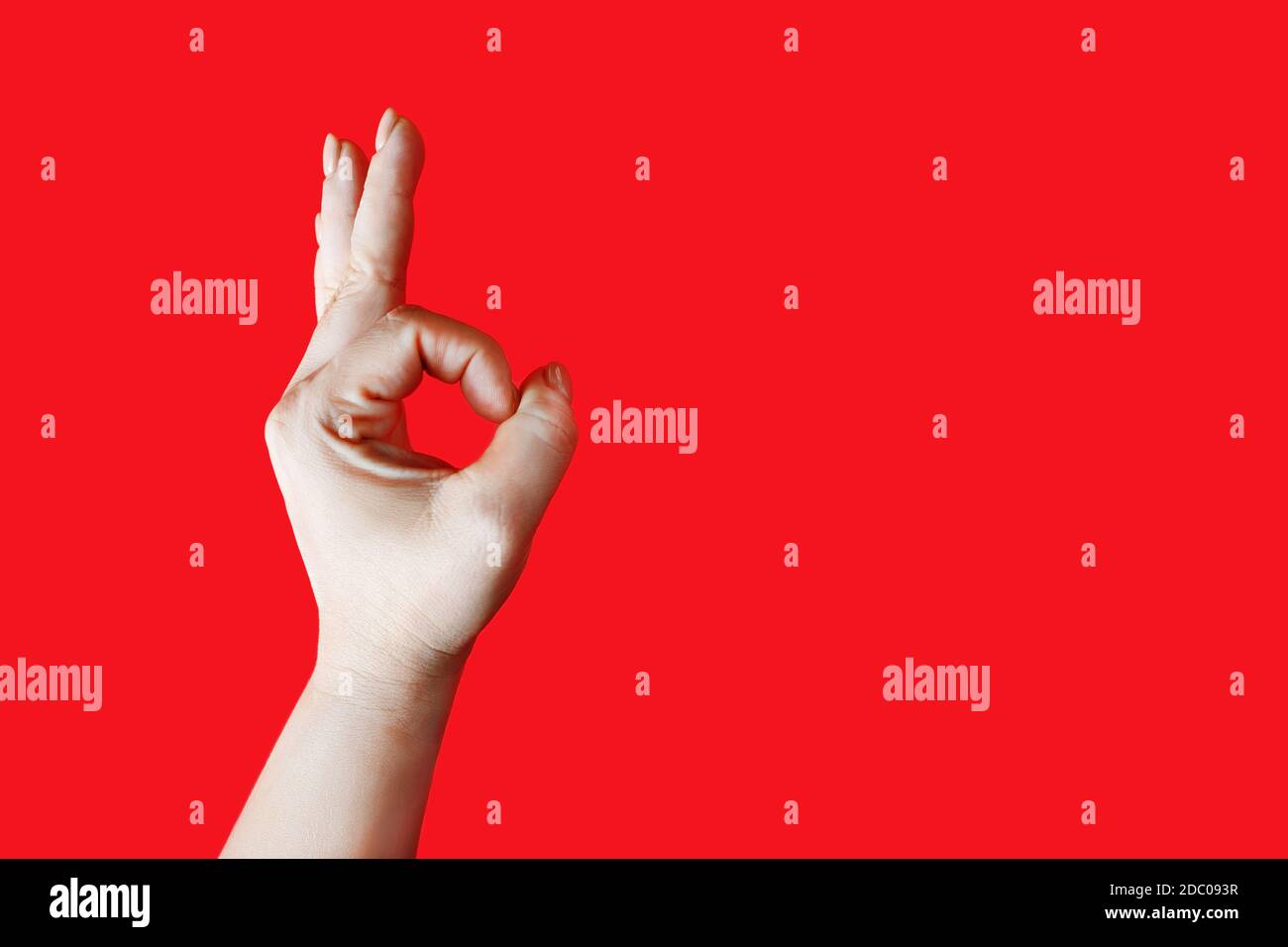 Female hand shows gesture OK over red background. Hand ok sign Stock ...