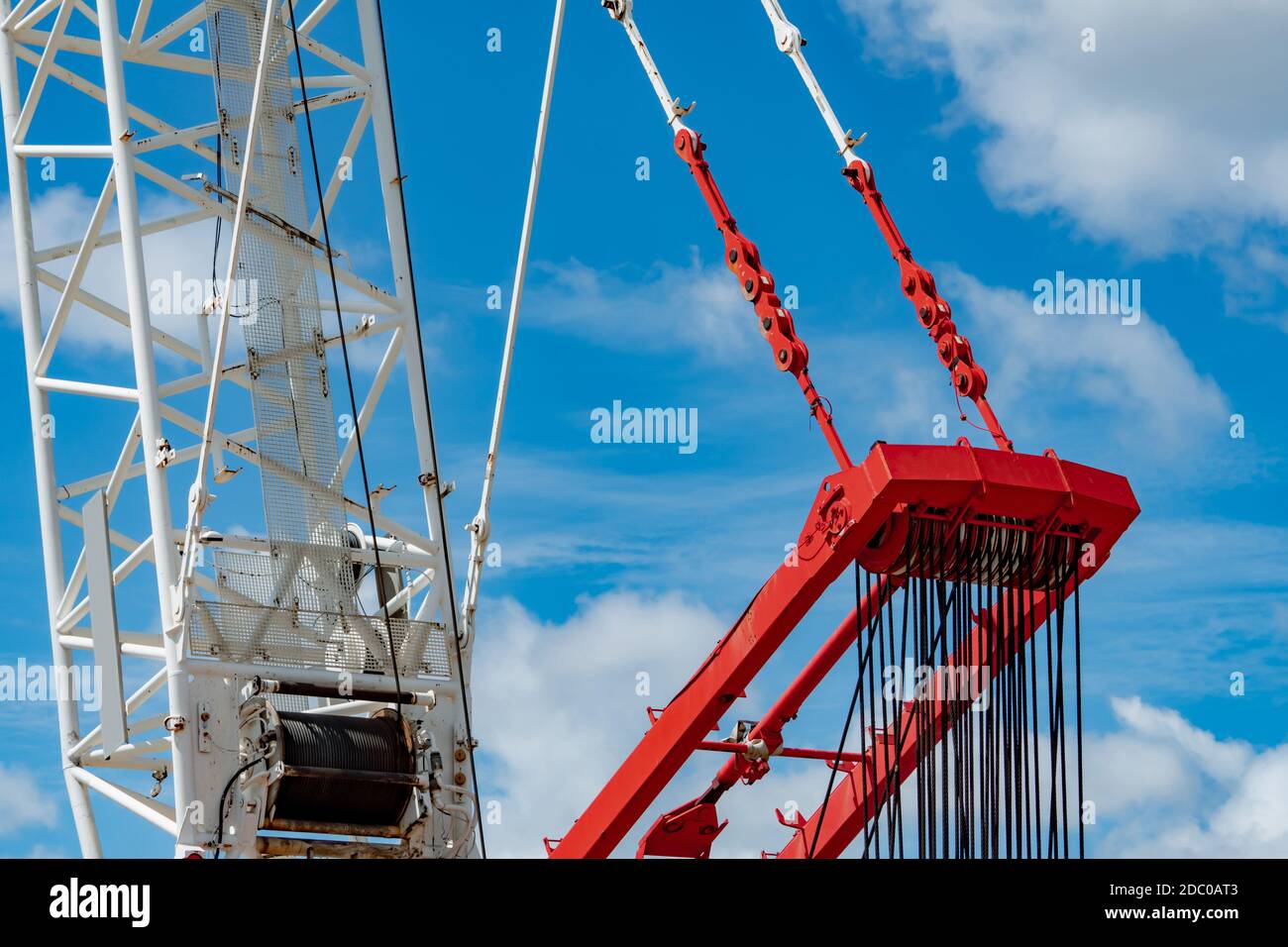 Closeup crawler crane with wire rope sling on crane reel against blue ...