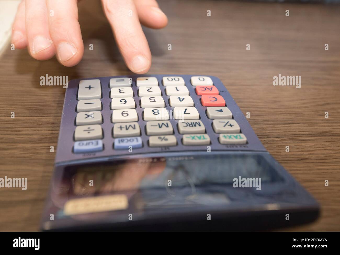 typing numbers in a pocket calculator with a LCD display Stock Photo ...