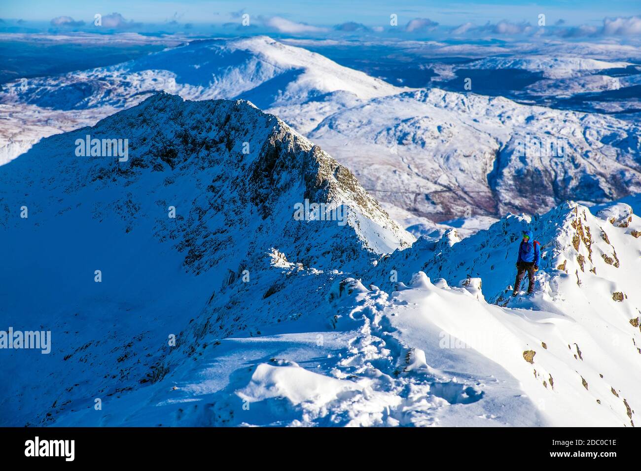 A walker / mountaineer on Crib Goch, Snowdon, in winter conditions ...